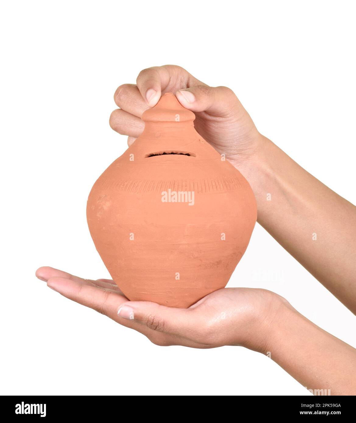 Hand holding indian piggy bank gullak on white background Stock Photo ...