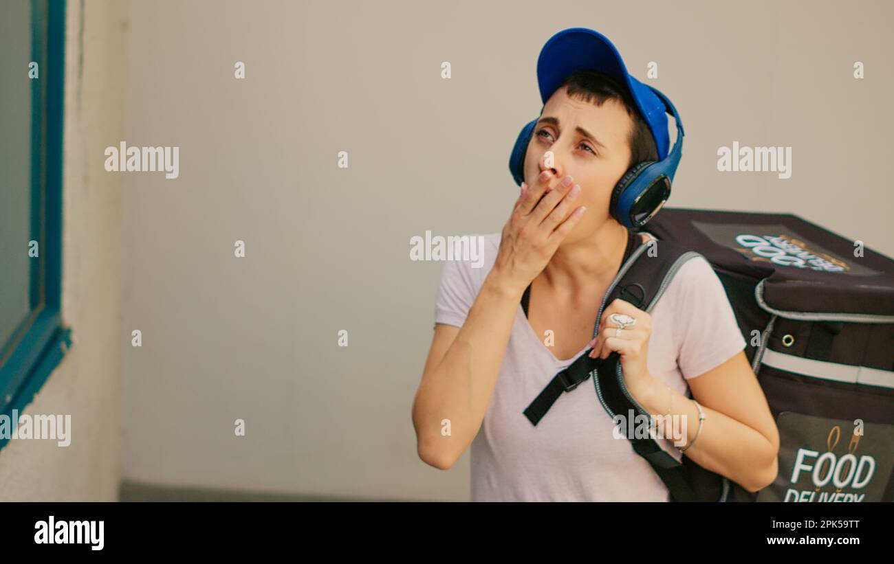 Tired food delivery employee yawning hi-res stock photography and ...