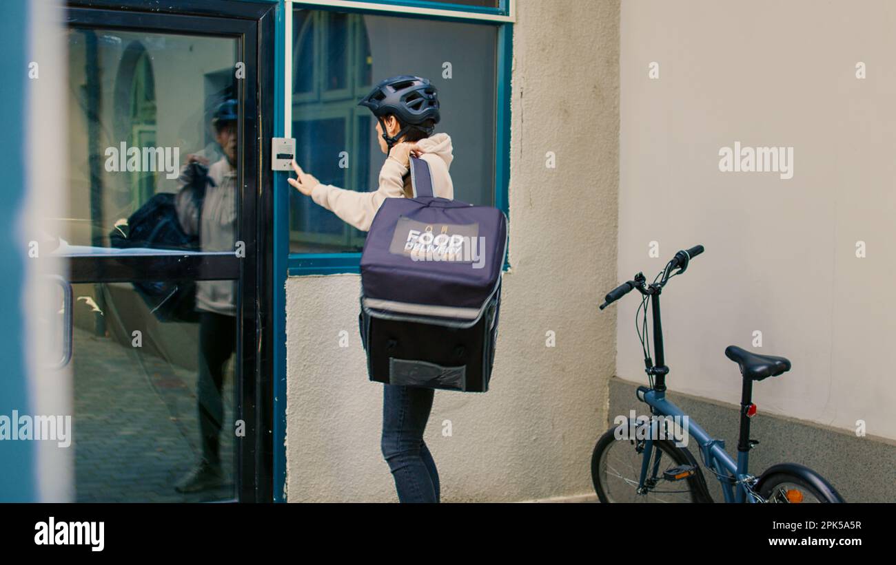 Woman delivery courier giving fastfood package in paper bag to customer ...