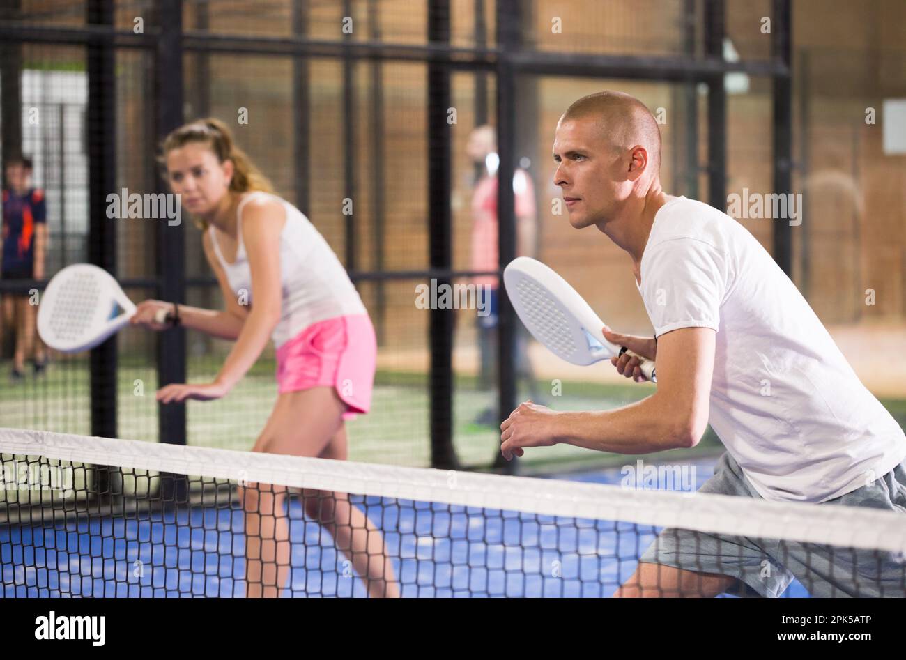 Concentrated paddle tennis player preparing to hit forehand Stock Photo ...