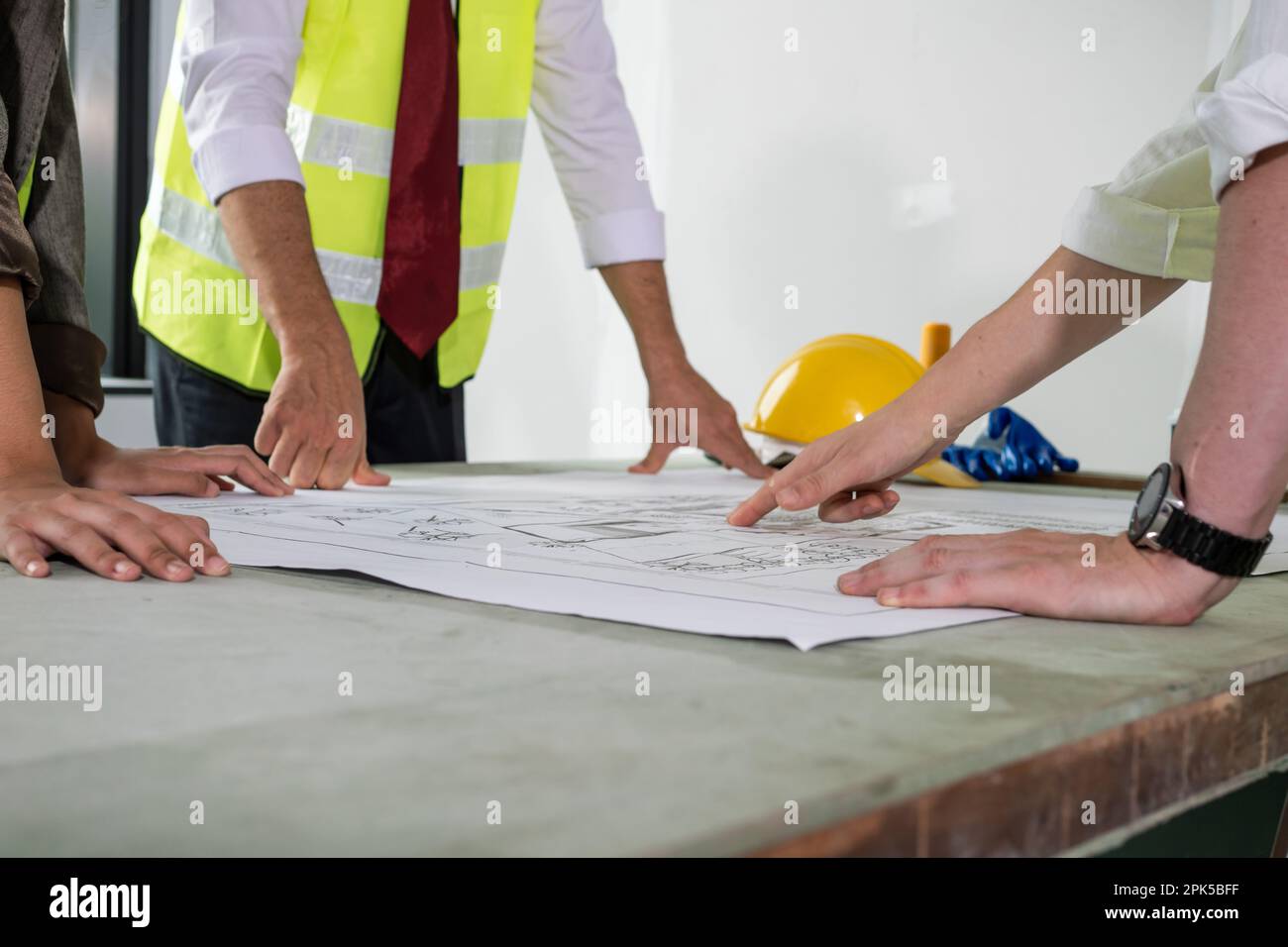 Professional construction engineers team using blueprint of project ...