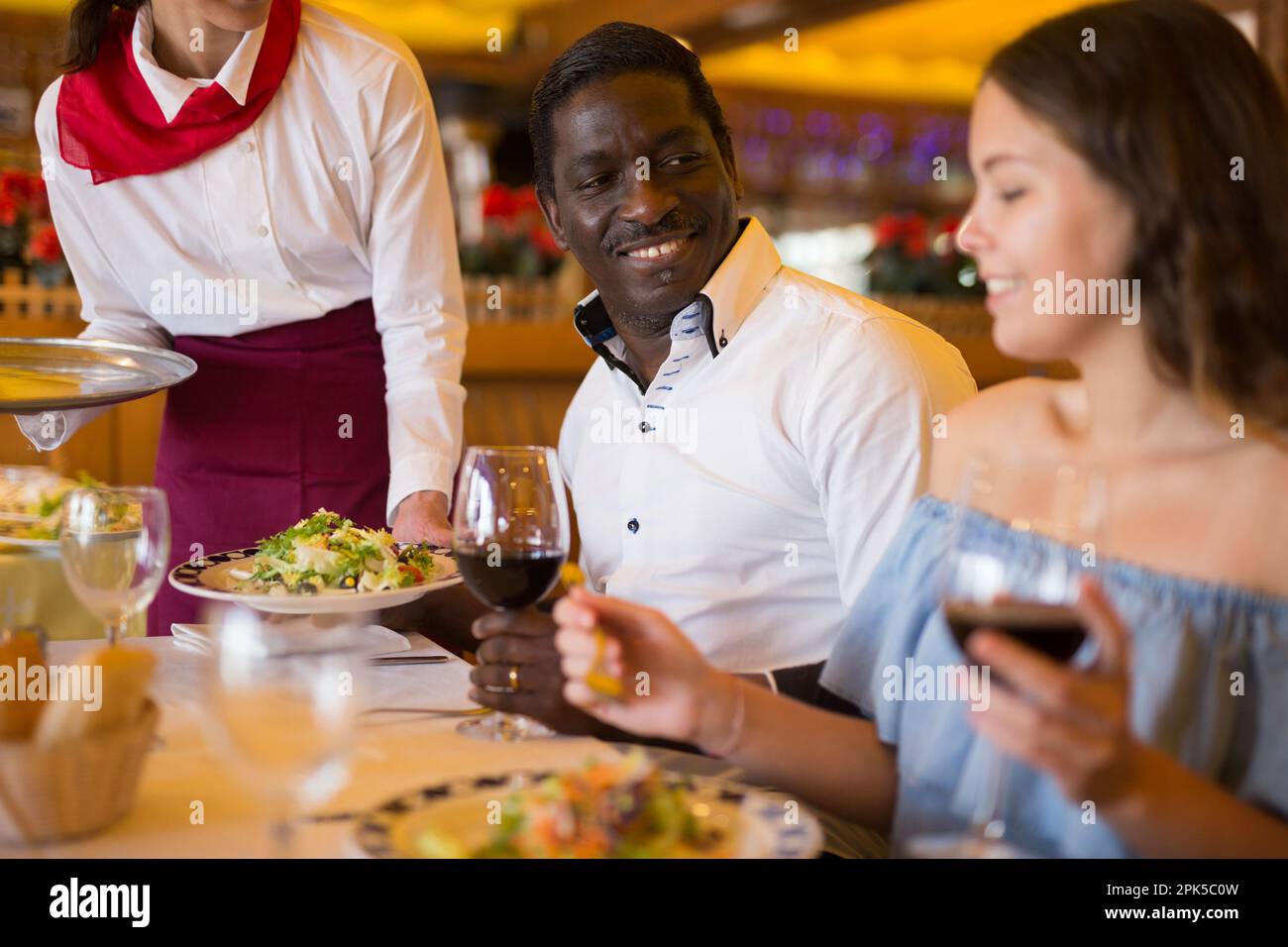 Ordinary female waiter carrying order for visitors in restaurant Stock ...