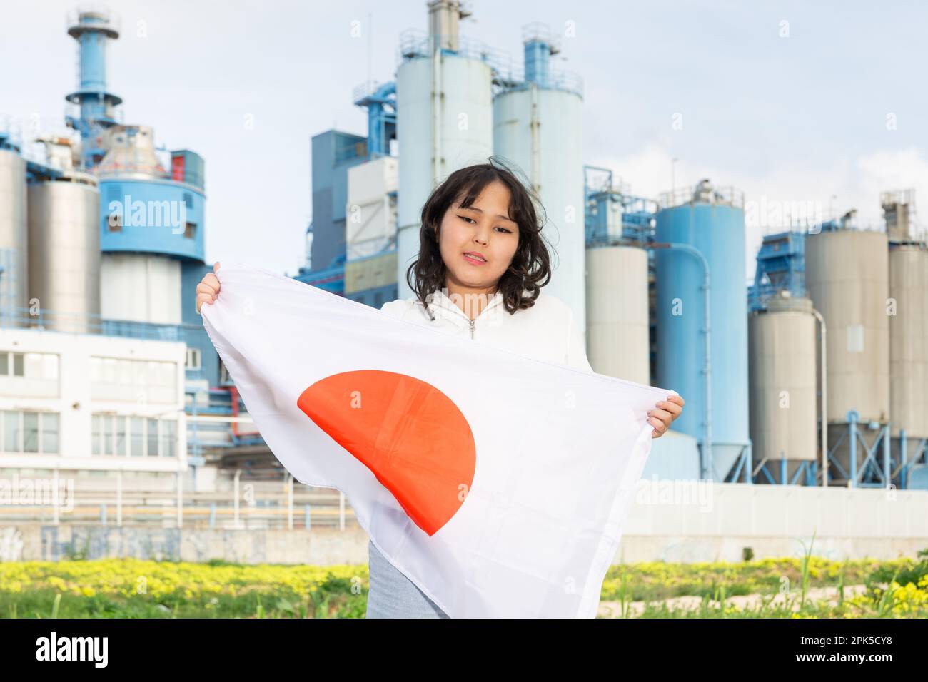 National flag of Japan in hands of girl against background of modern ...