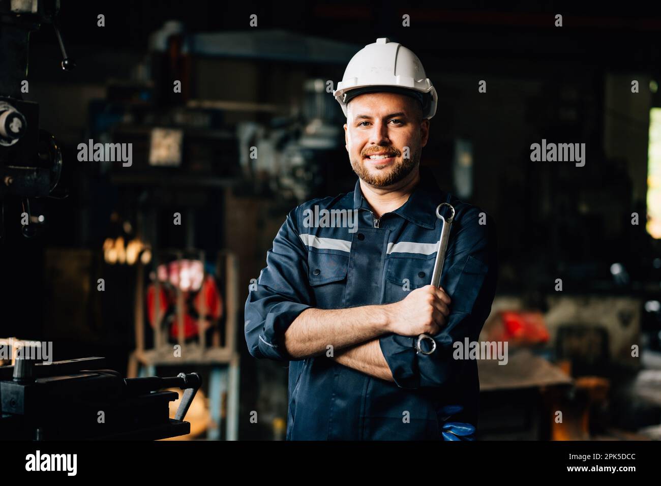 Portrait of male engineer worker smiling at manufacturing plant factory ...