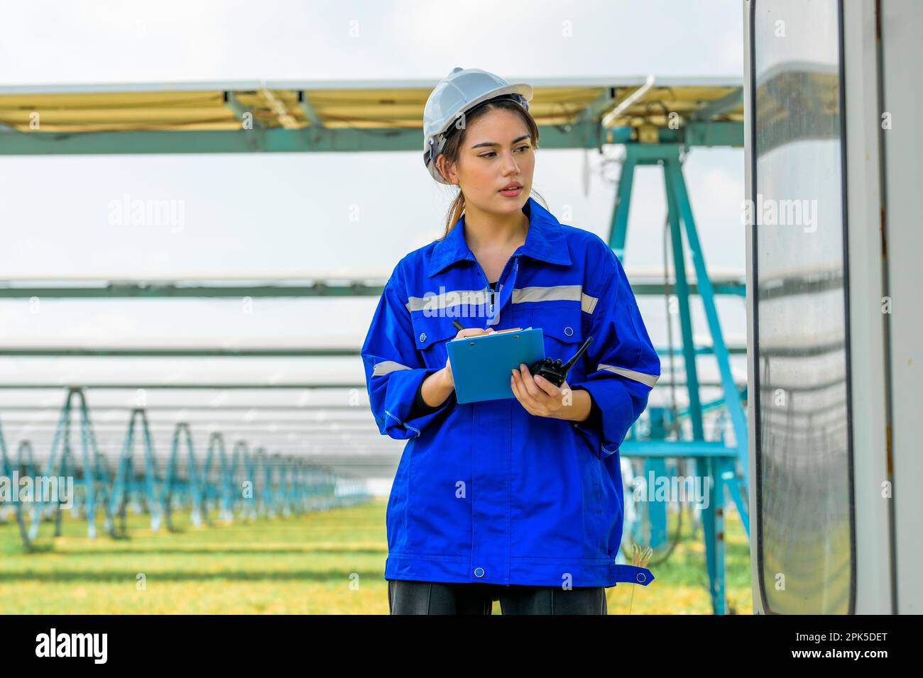 Workers installing solar panels, Engineer team at solar panel farm ...