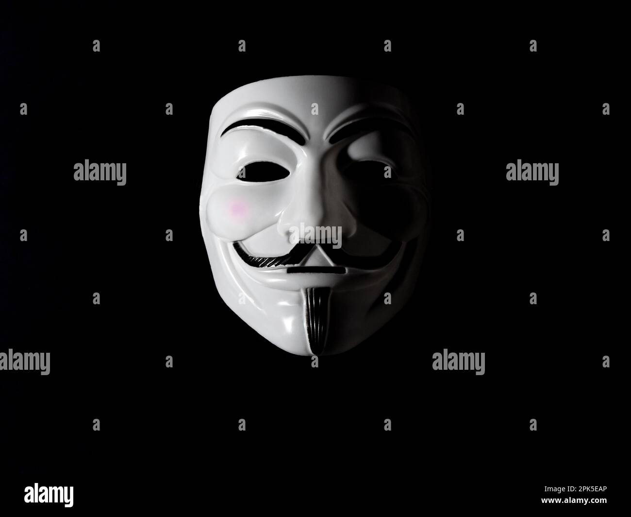 Guy Fawkes mask half hidden in the shadows Stock Photo - Alamy