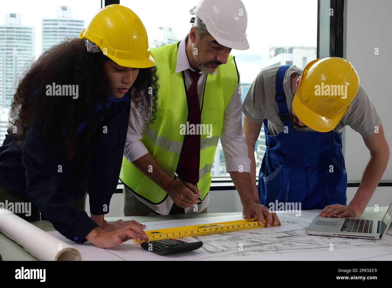 Professional construction engineers team using blueprint of project ...