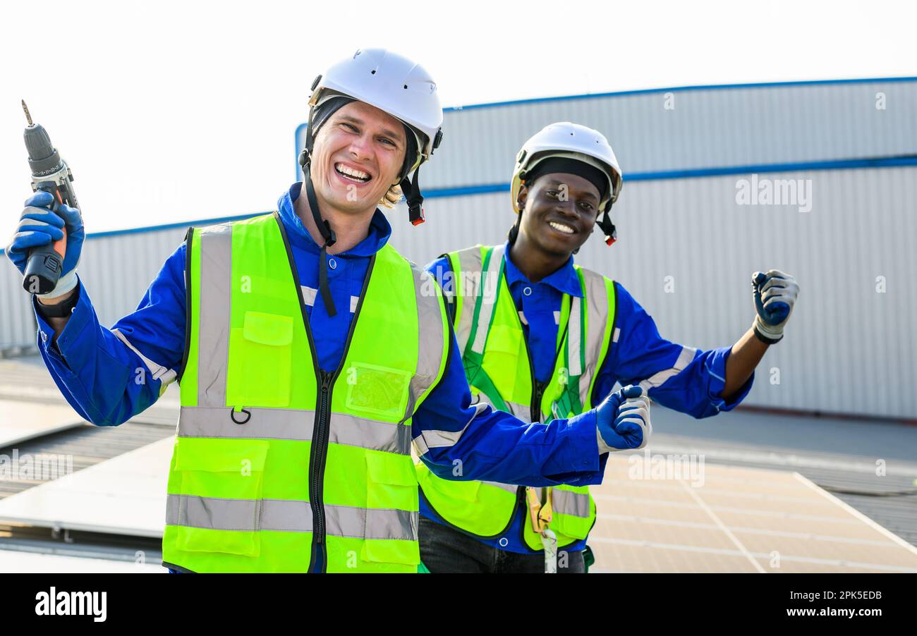 Happy technicians workers installing solar panels at solar cell farm ...
