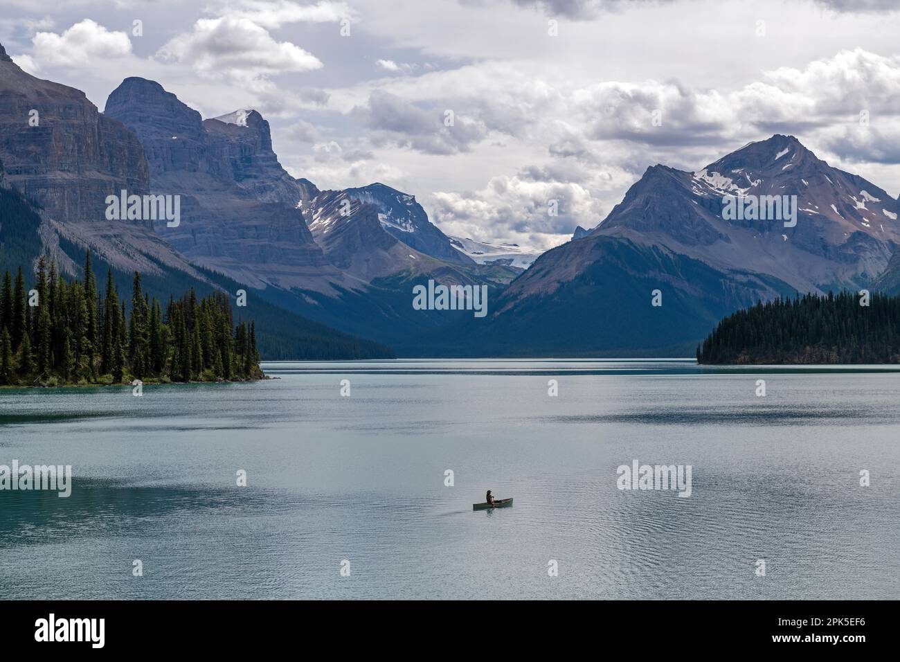 One man kayaking on Maligne Lake seen from Spirit Island, Jasper ...