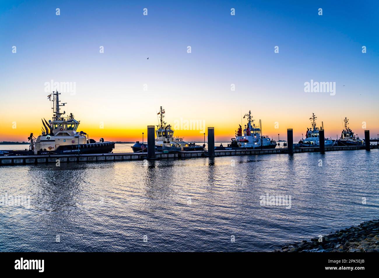 The tugboat pier, harbour tugs waiting for the next assignment, at the New Harbour, sunset over ...