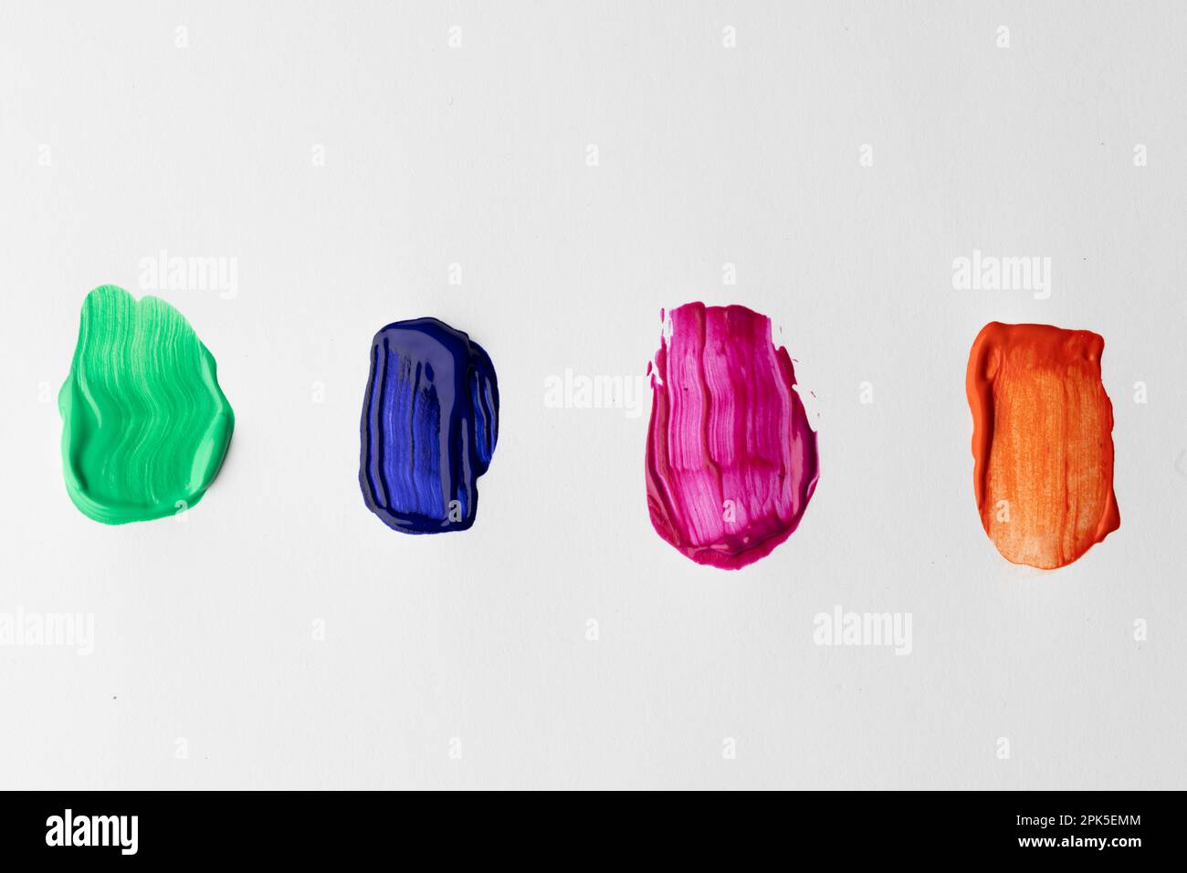 Close up of multi coloured paint shapes on white background with copy ...