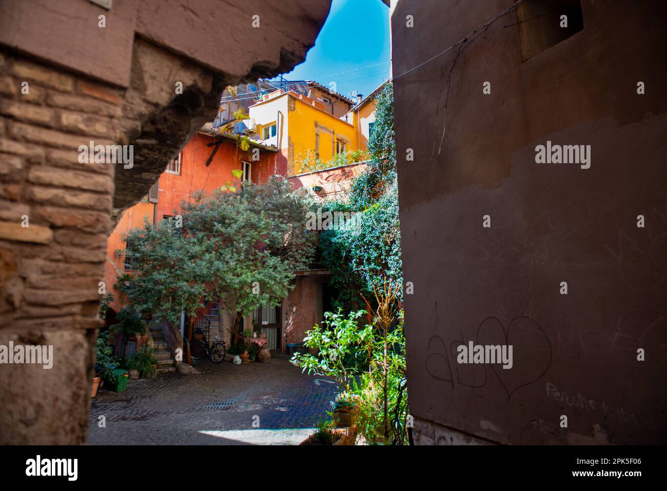 Small courtyard in Rome , with rustic ocher houses and vine trees Stock ...