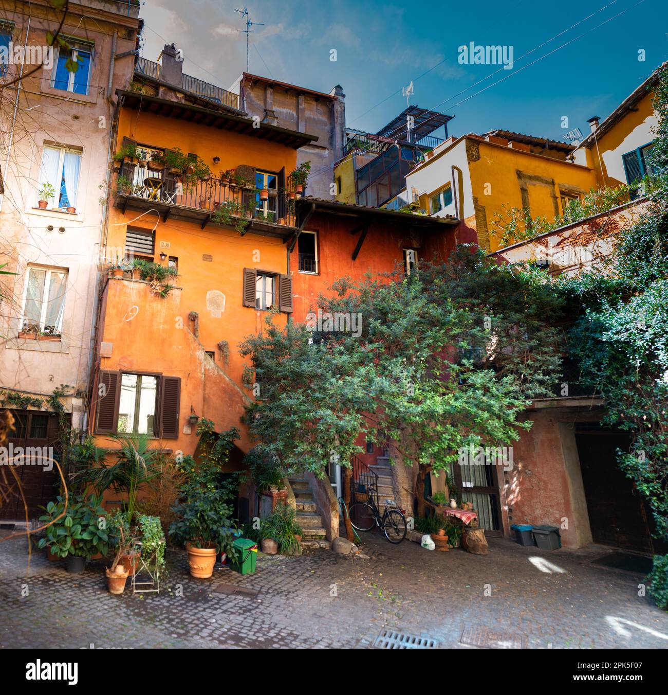 Small courtyard in Rome , with rustic ocher houses and vine trees Stock ...