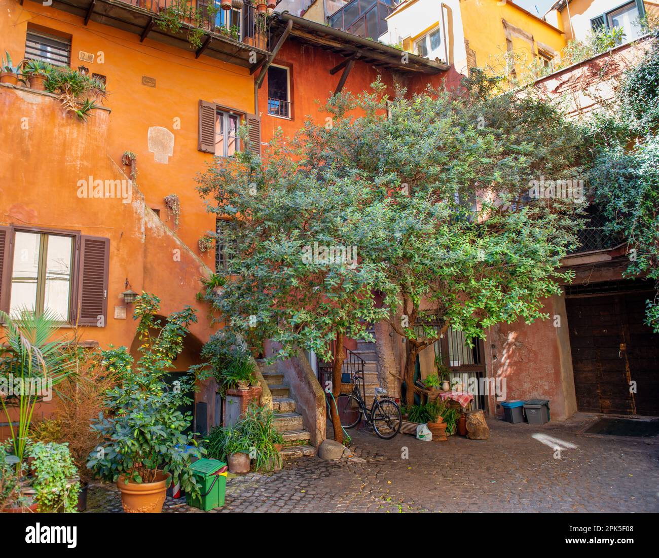 Small courtyard in Rome , with rustic ocher houses and vine trees Stock ...