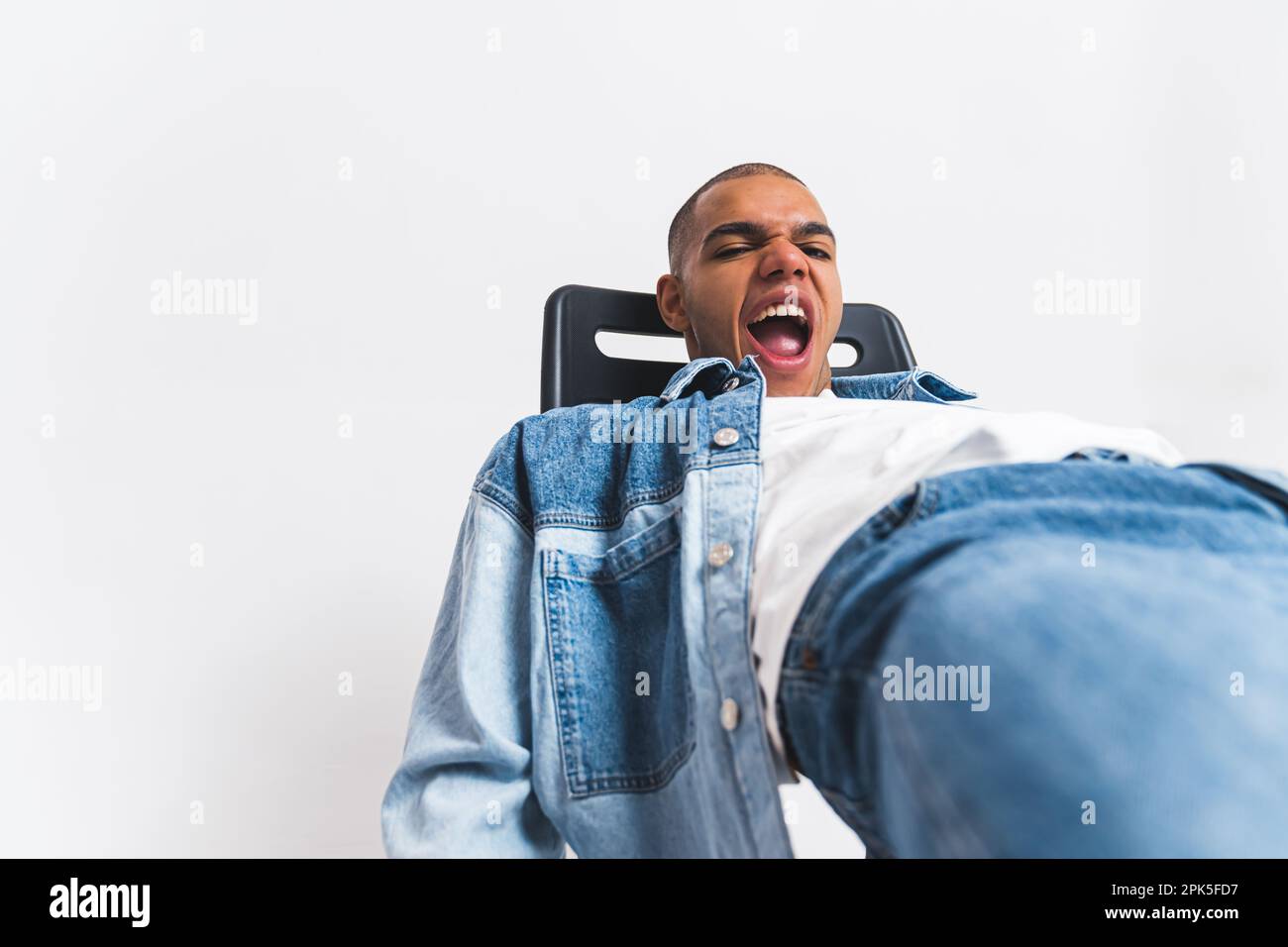 Unconventional pose during fashion photoshoot. Young adult male model ...