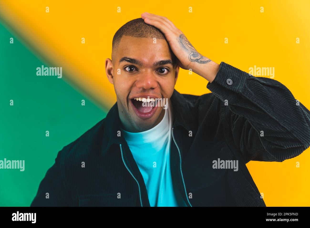 Funny shocked young adult man with open mouth looking at camera and ...