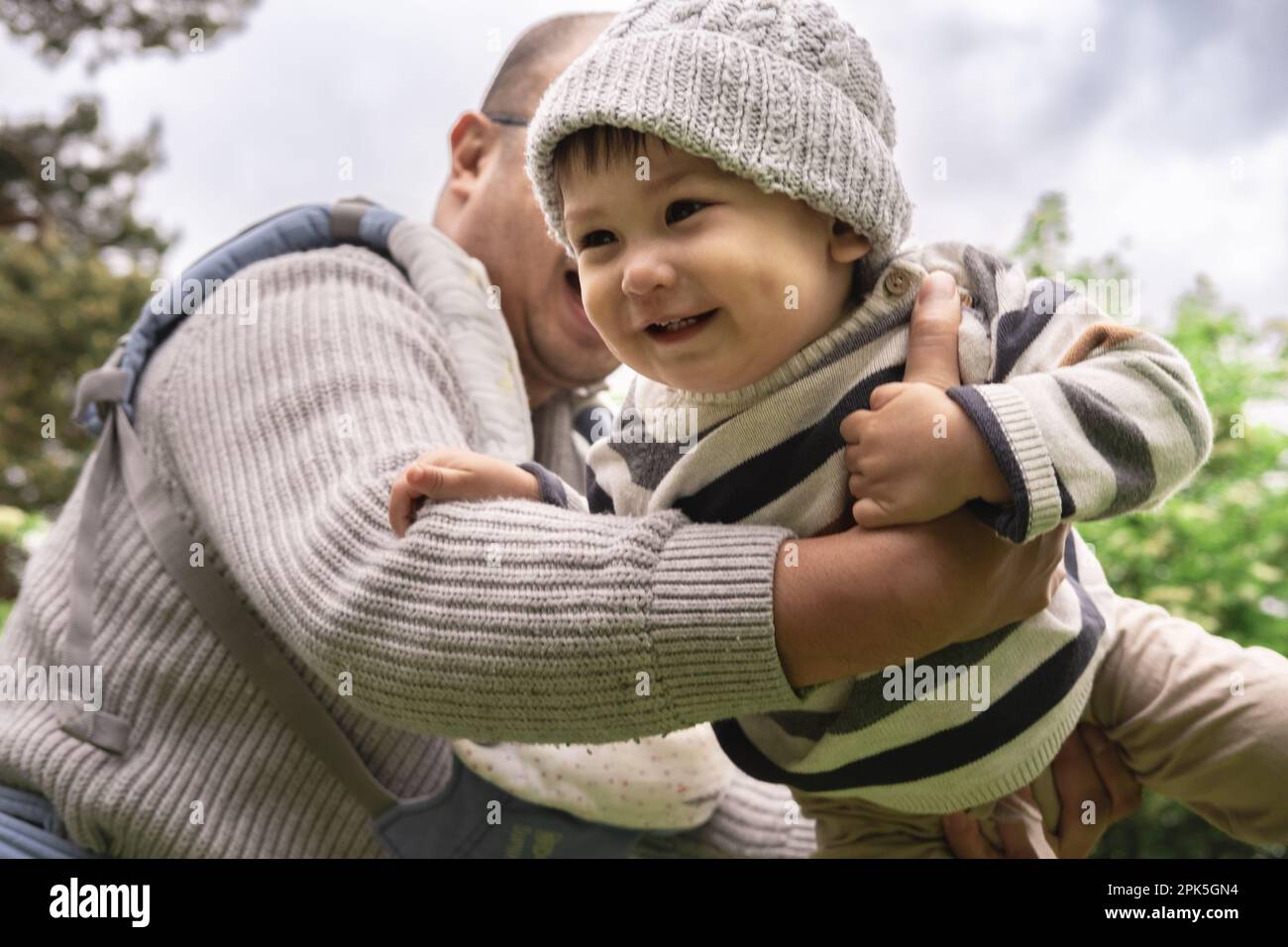 New dad playing with sweet baby, lifting, throwing adorable infant up ...