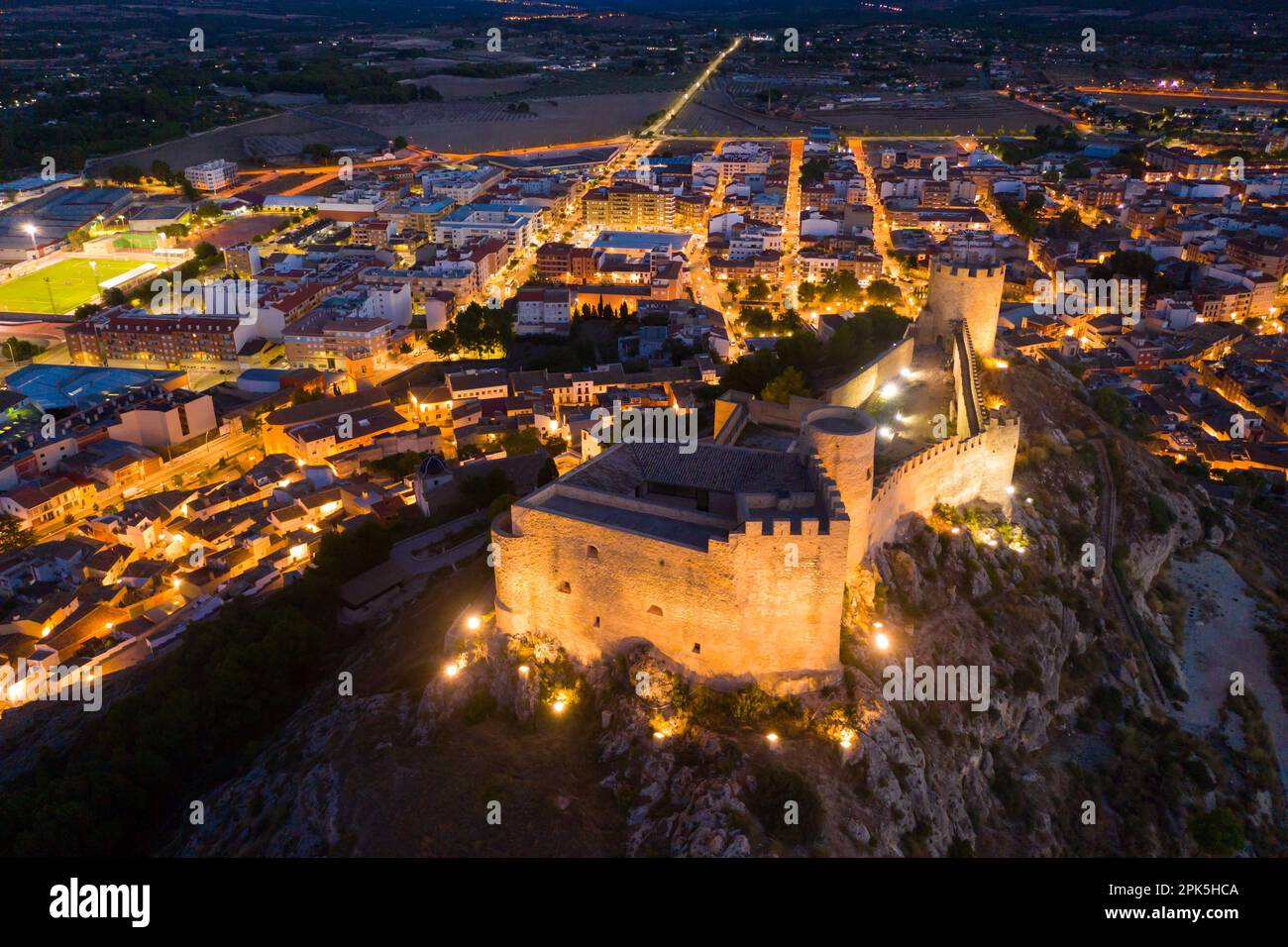 Night view of illuminated hilltop walled castle in Castalla, Spain ...