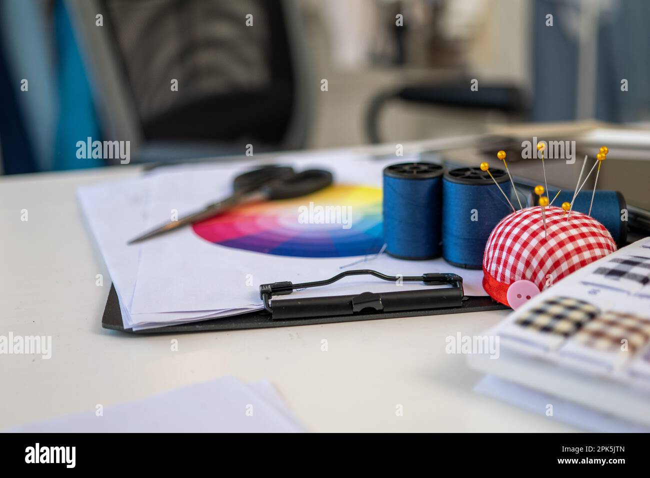 Sewing machine and accessories on table at dressmaking workshop studio ...