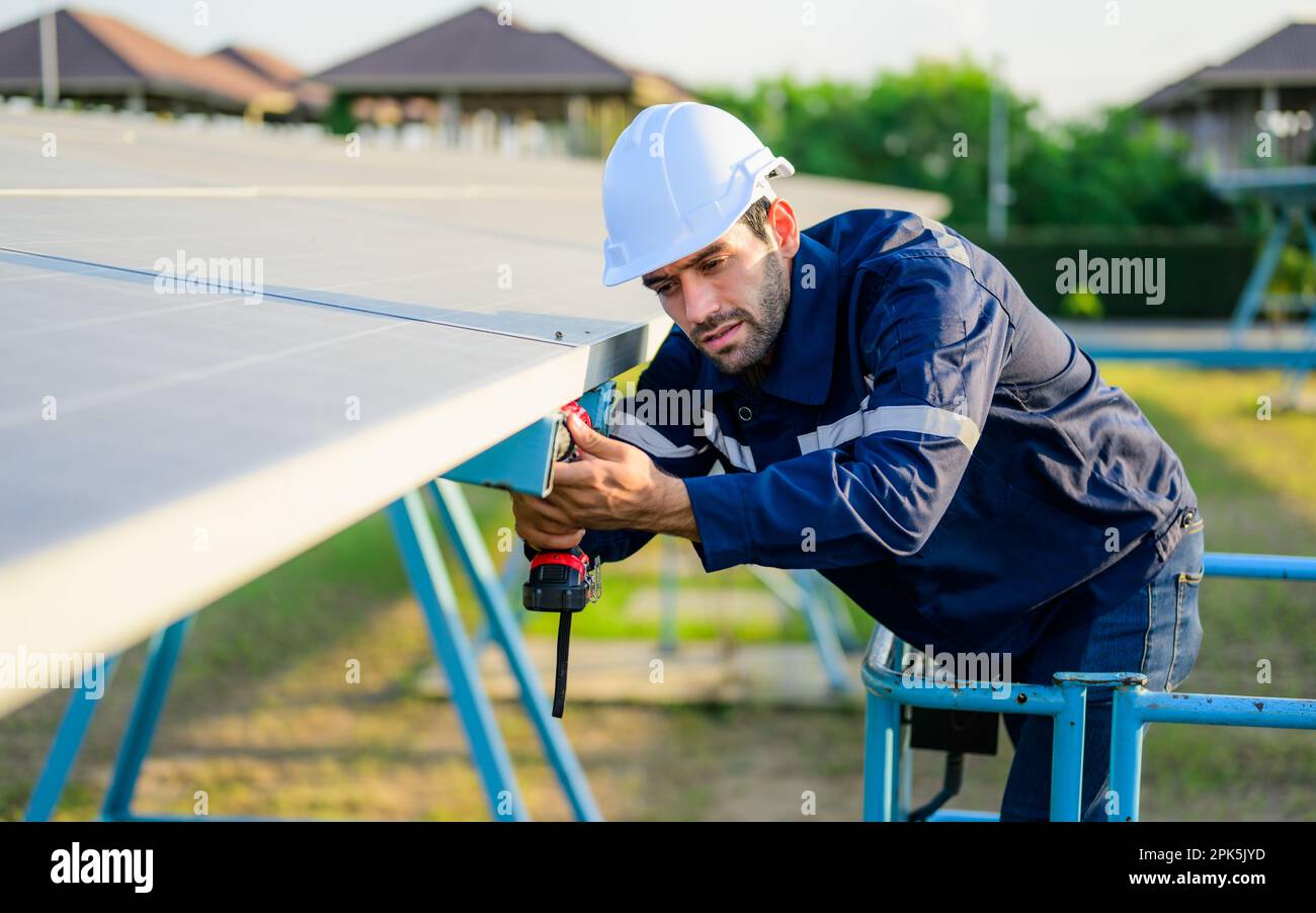 Male technician worker installing solar panels at solar cell farm Stock ...