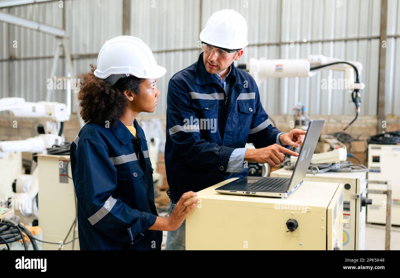Engineer technician controlling robotic hi-res stock photography and ...