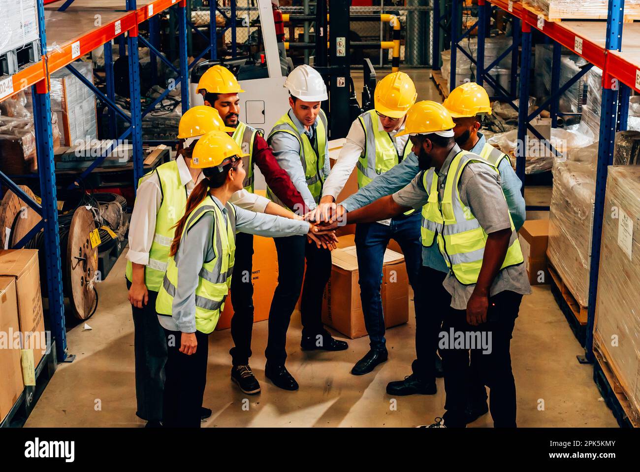 Professional warehouse worker team celebrating success in warehouse ...