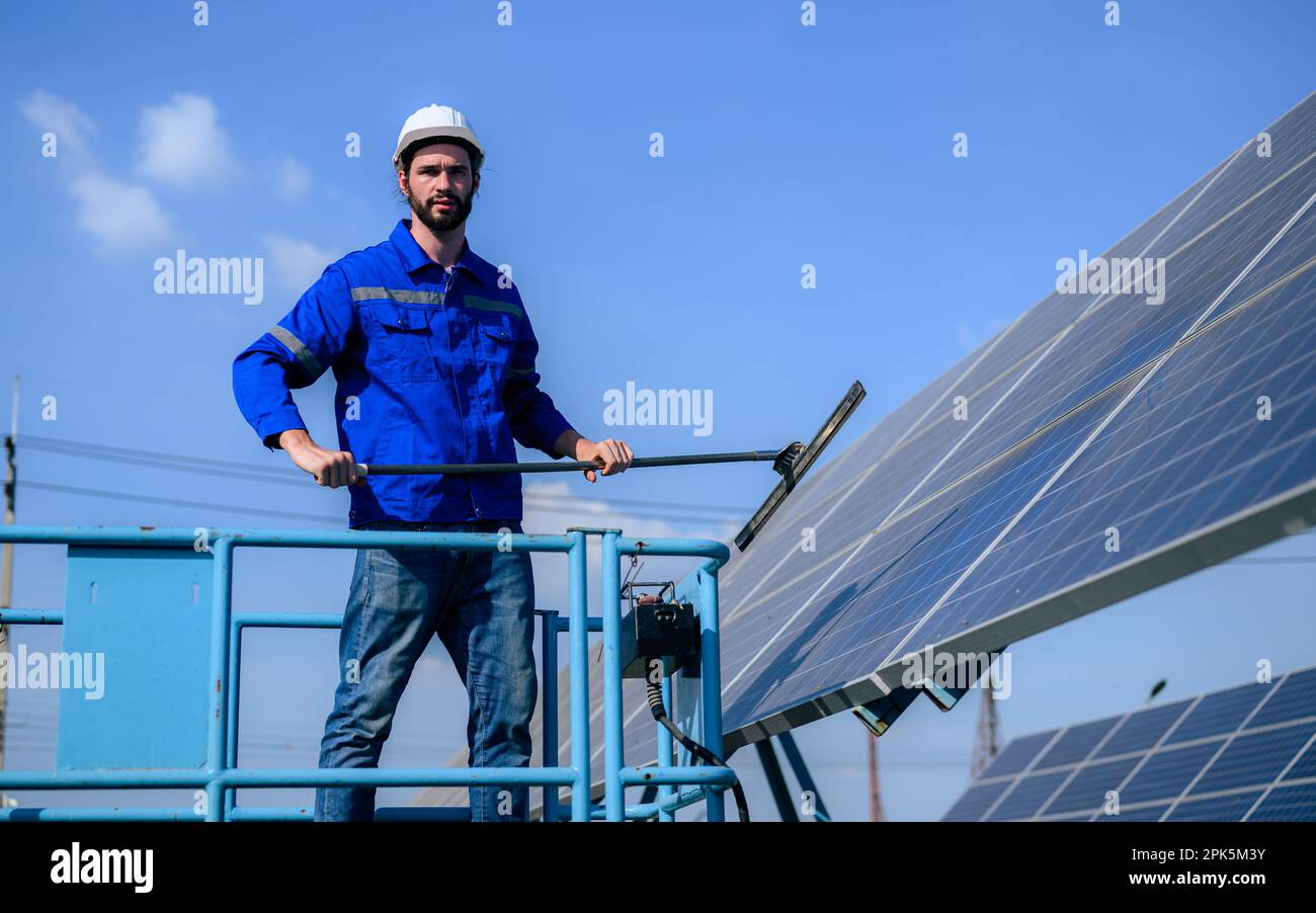 Worker cleaning solar panel at solar cell farm Stock Photo - Alamy
