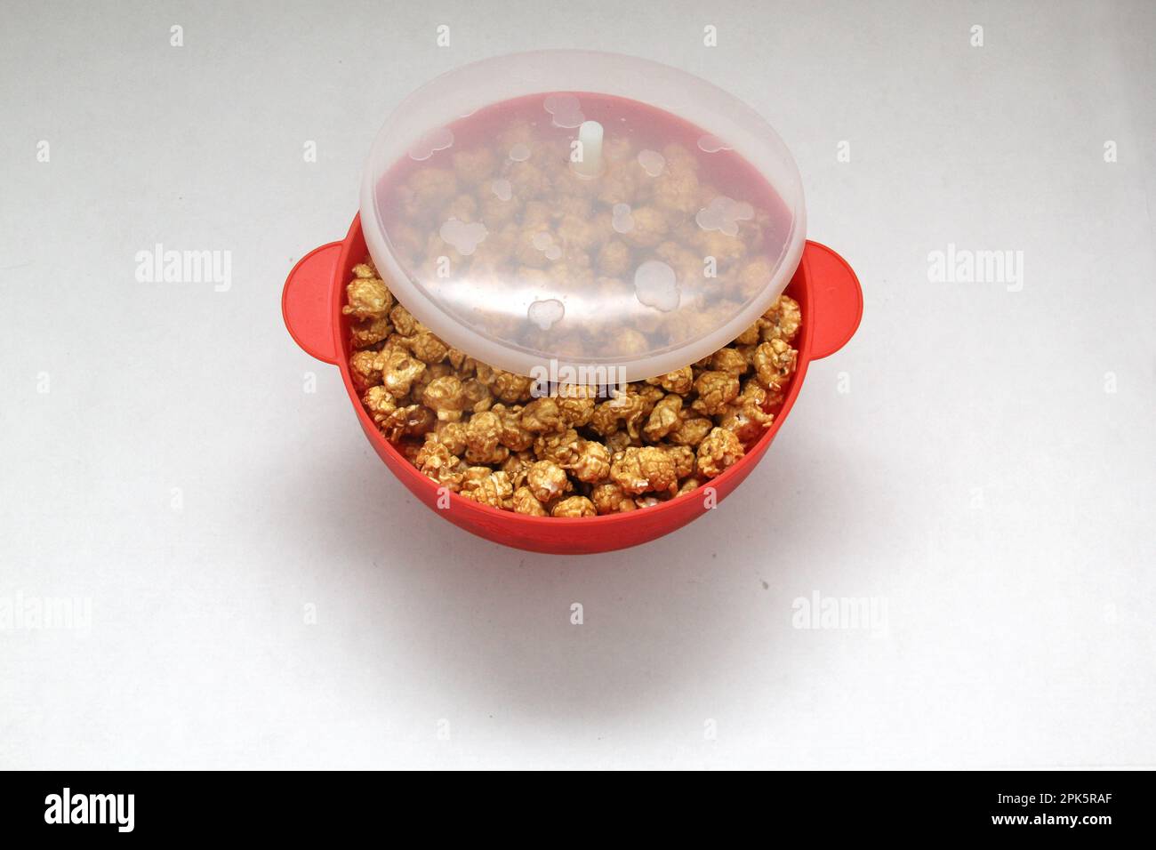 Collapsible red silicone container for microwave popcorn Stock Photo ...