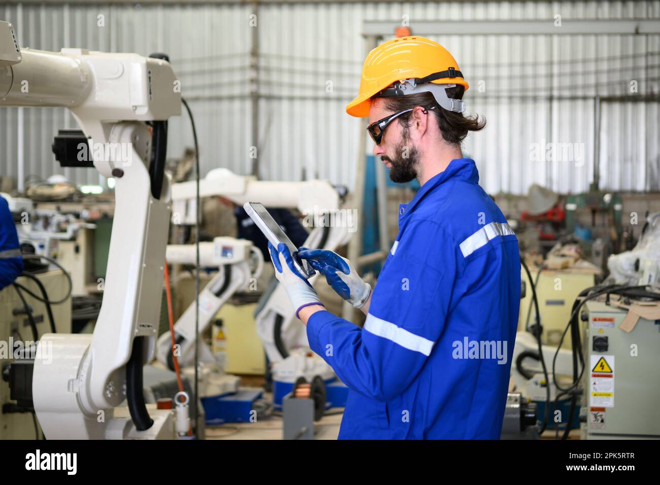 Engineer technician controlling robotic hi-res stock photography and ...