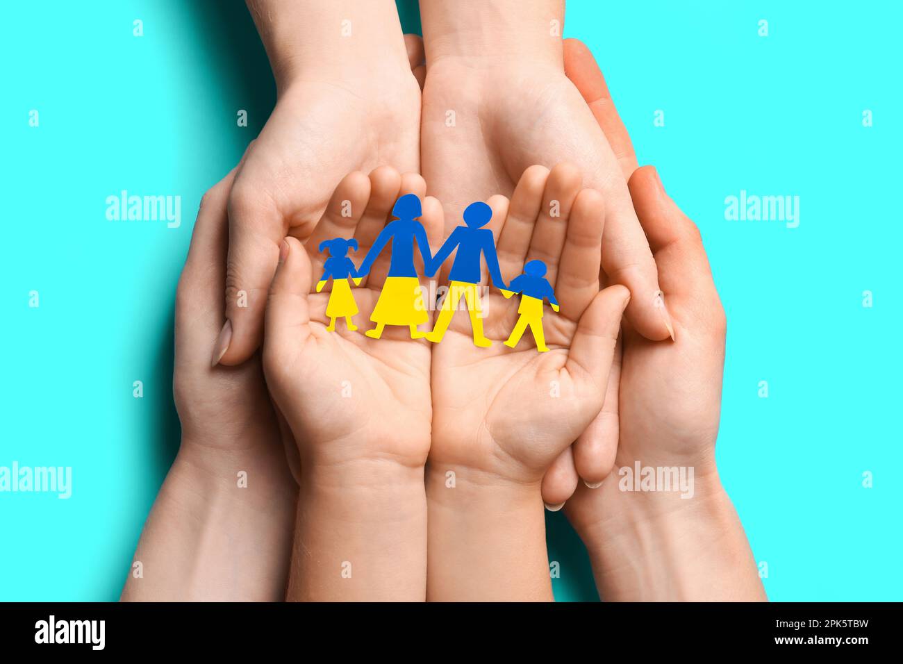 Parents and child holding paper family cutout in colors of Ukrainian ...
