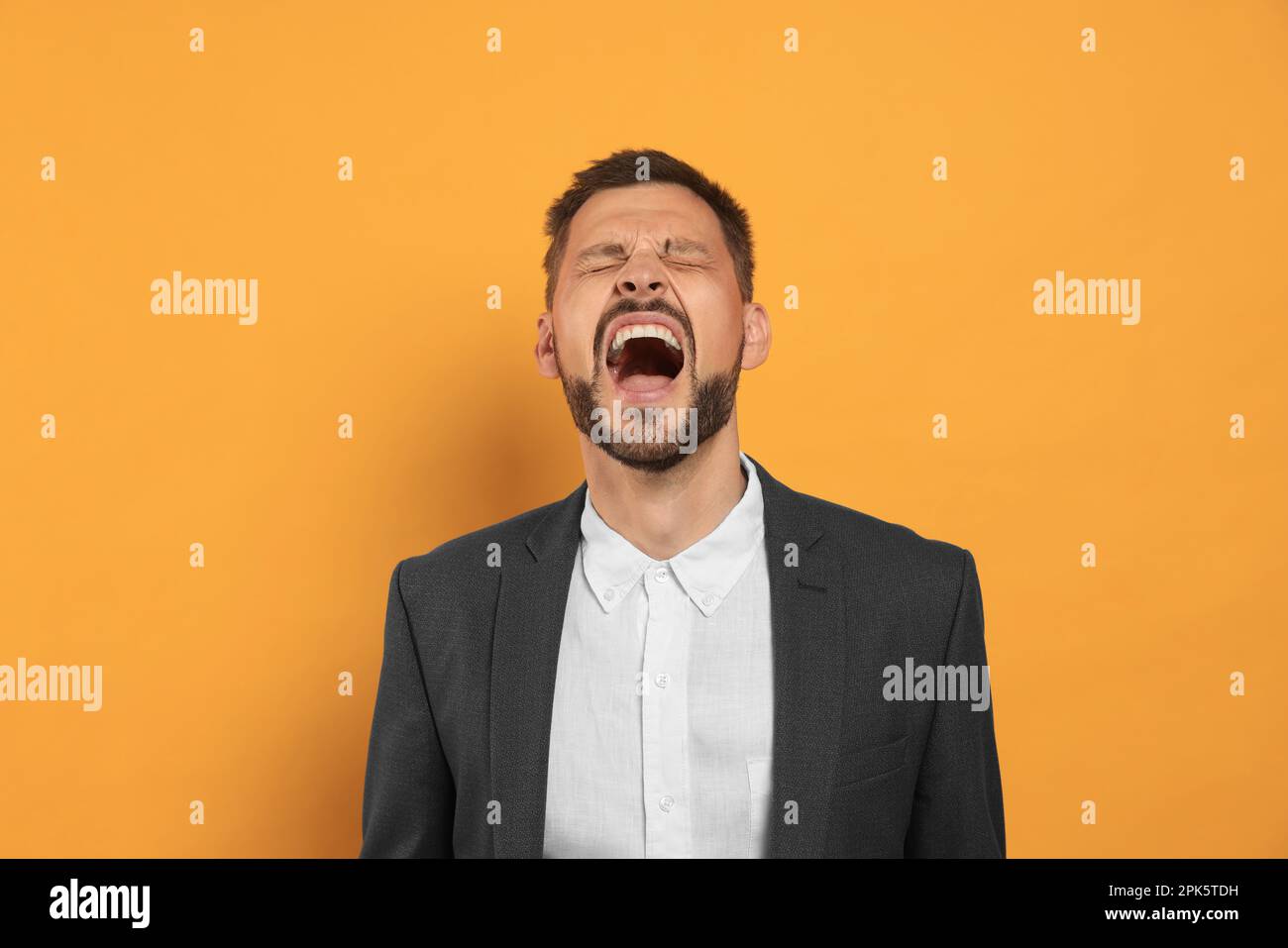 Aggressive man shouting on orange background. Hate concept Stock Photo ...