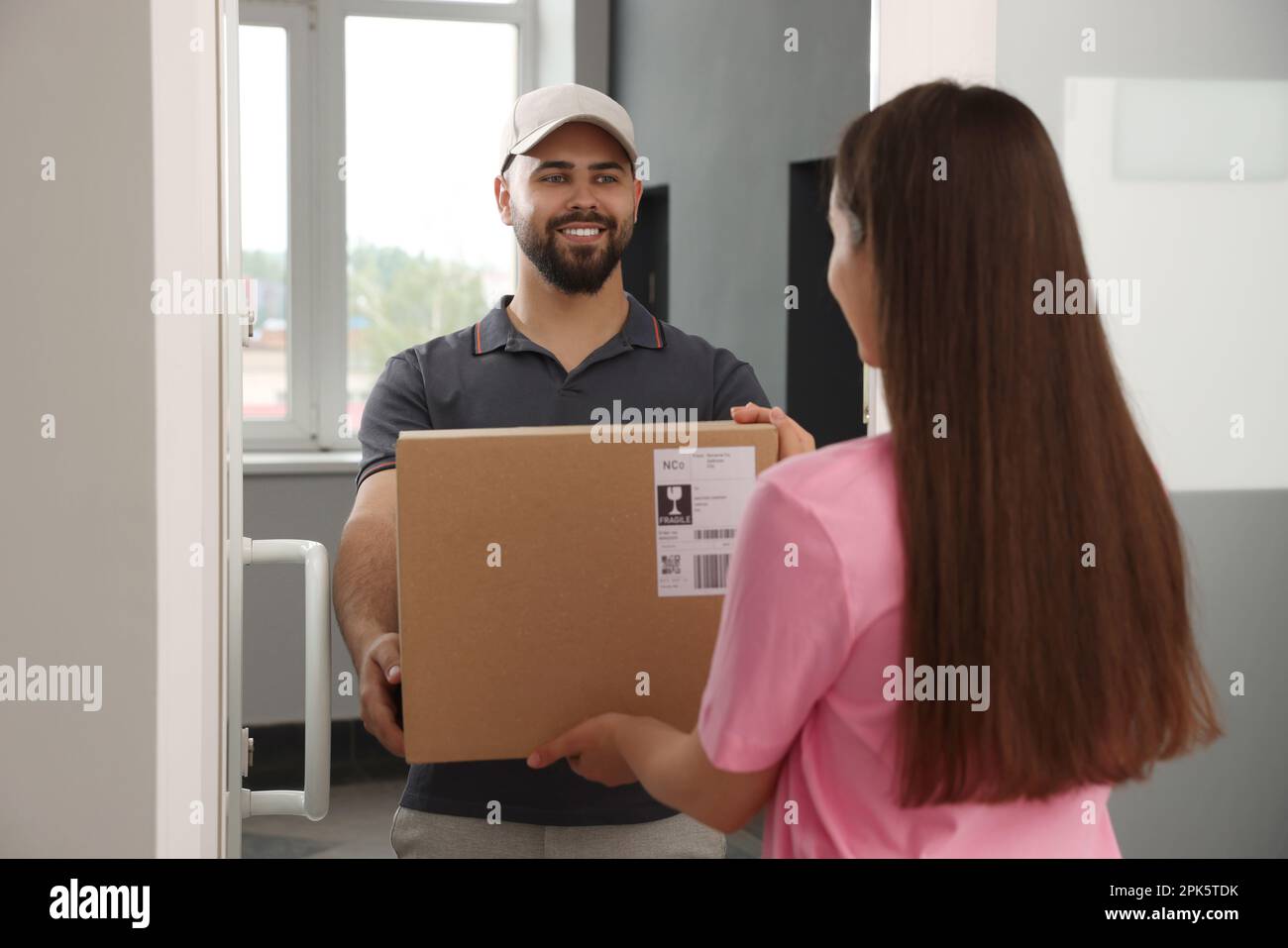 Woman receiving parcel hi-res stock photography and images - Alamy