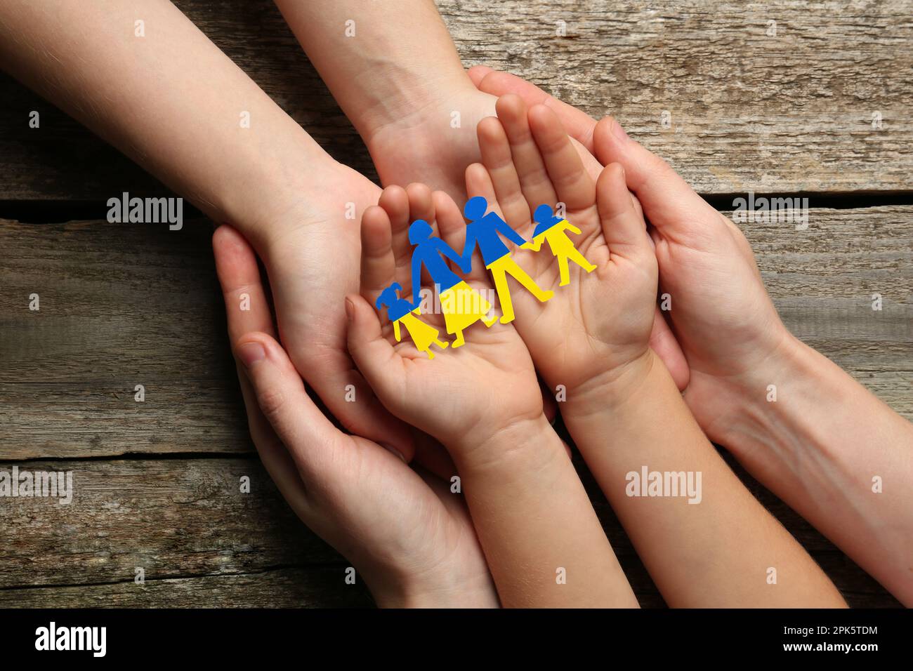 Parents and child holding paper family cutout in colors of Ukrainian ...