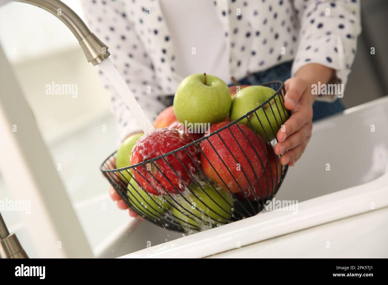 Woman washing fresh apples in kitchen sink, closeup Stock Photo - Alamy