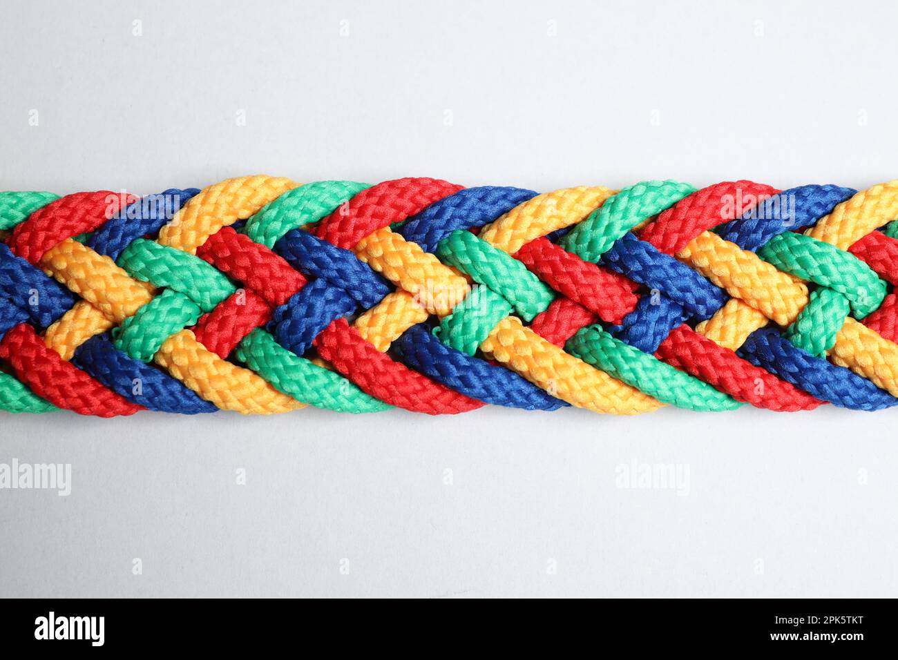 Braided colorful ropes isolated on white, top view. Unity concept Stock ...