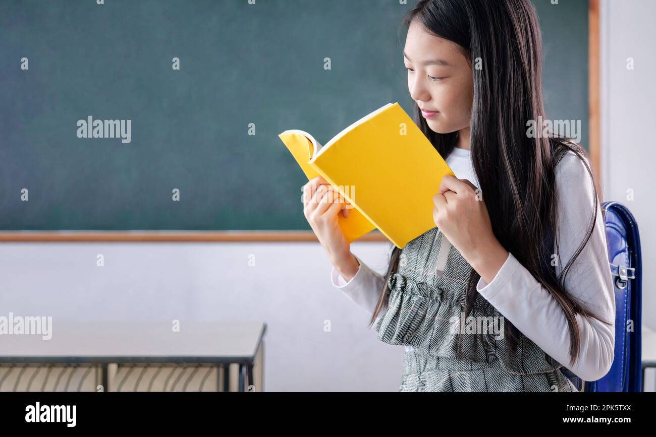 Student studying and reading textbook with happiness in classroom Stock ...