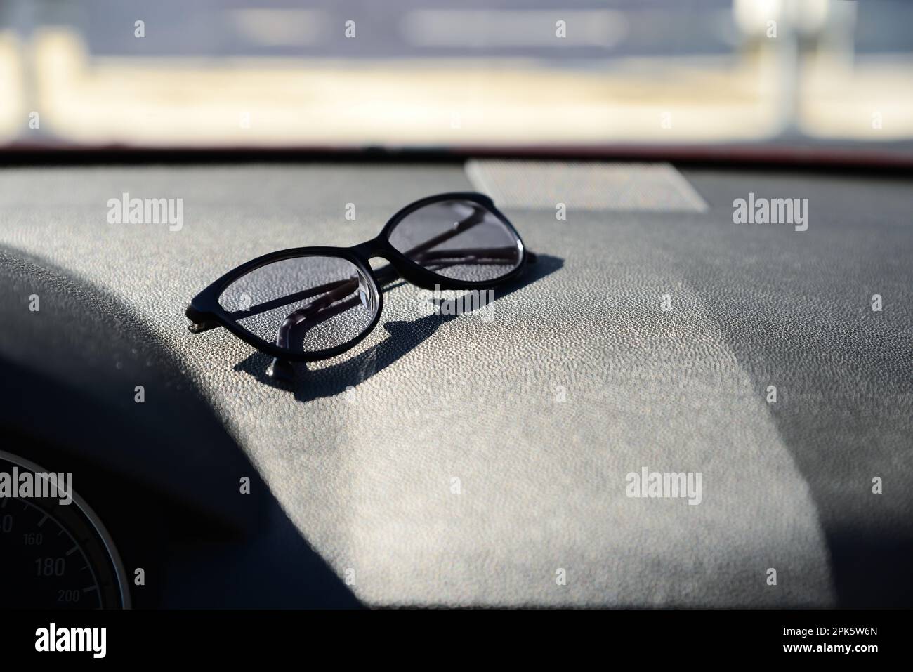 Stylish glasses on dashboard in car, space for text Stock Photo - Alamy