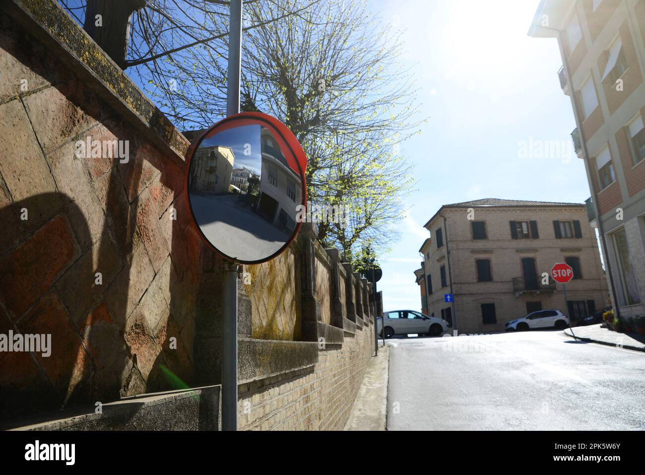 Traffic mirror on city street, space for text Stock Photo - Alamy