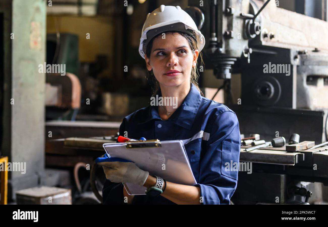 Young mechanical engineer repairing engine machine at repair shop Stock ...