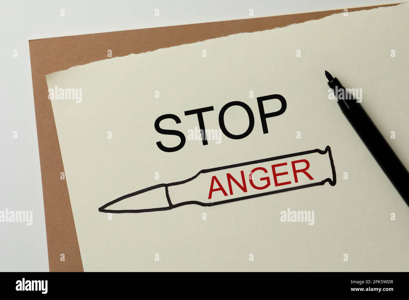 Sheet of paper with inscription Stop Anger and drawn bullet on white ...
