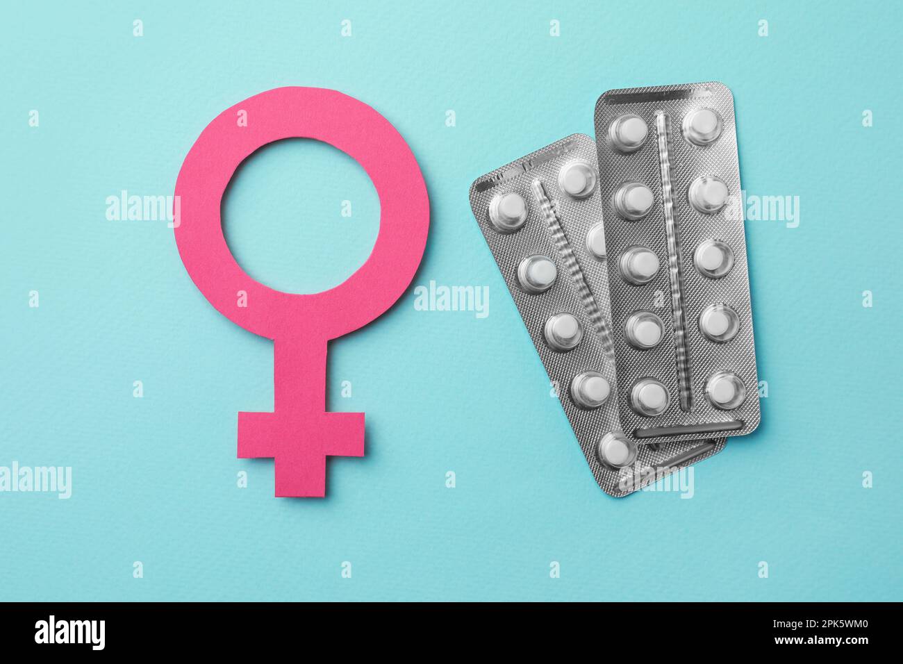 Female gender sign and blisters of pills on turquoise background, flat ...