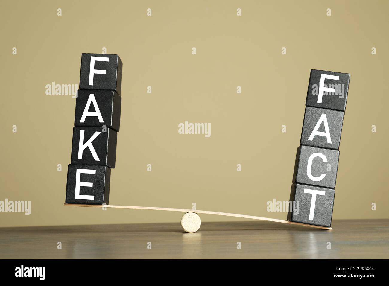 Wooden scale with words FAKE and FACT on table Stock Photo - Alamy