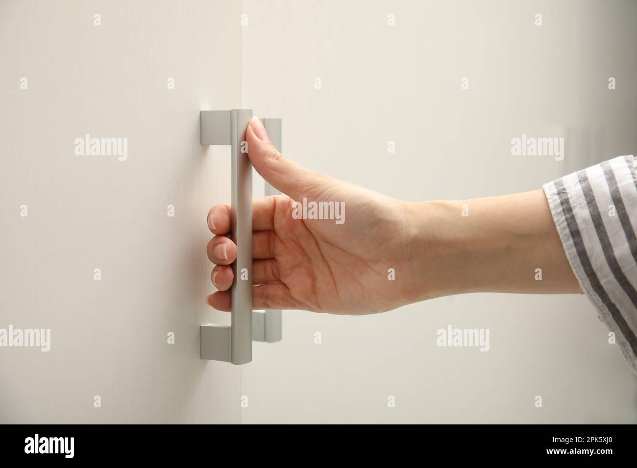 Woman pulling door hi-res stock photography and images - Alamy