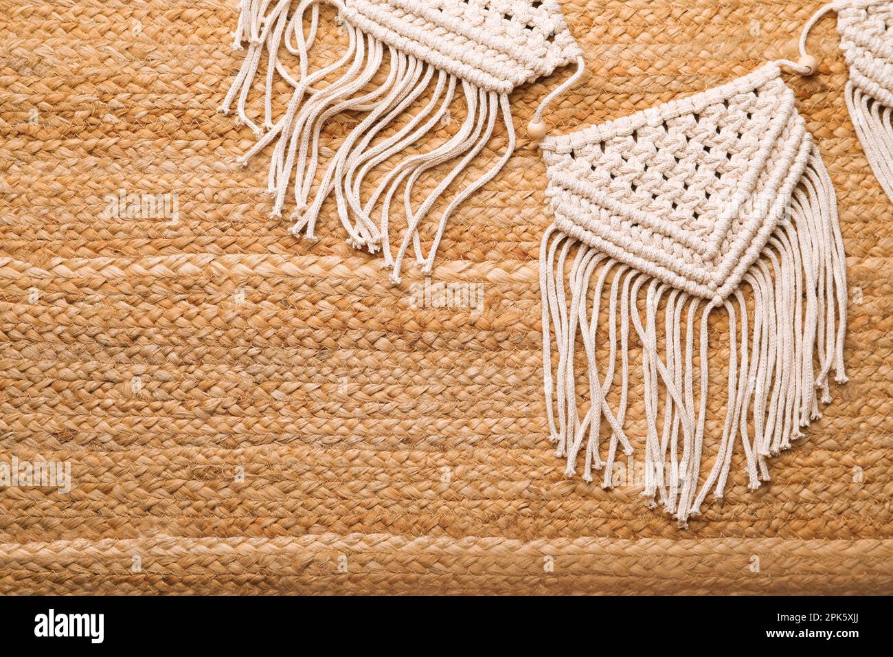Large macrame on wicker straw background, flat lay. Space for text ...