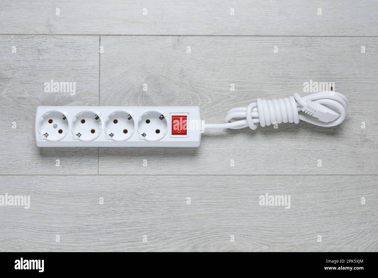 Power strip on wooden floor, top view. Electrician's equipment Stock ...
