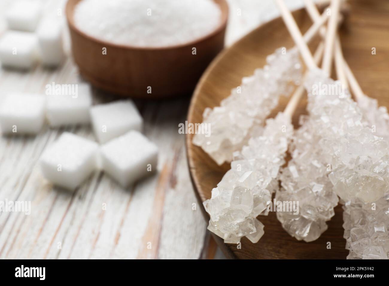Different types of sugar on white wooden table, closeup Stock Photo - Alamy