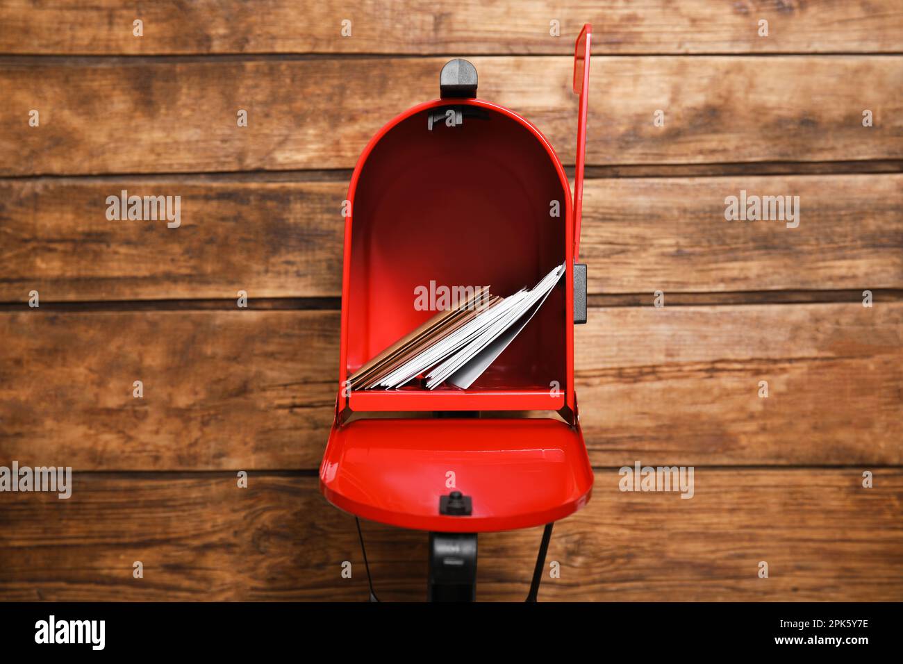 Open red letter box with envelopes against wooden background Stock ...