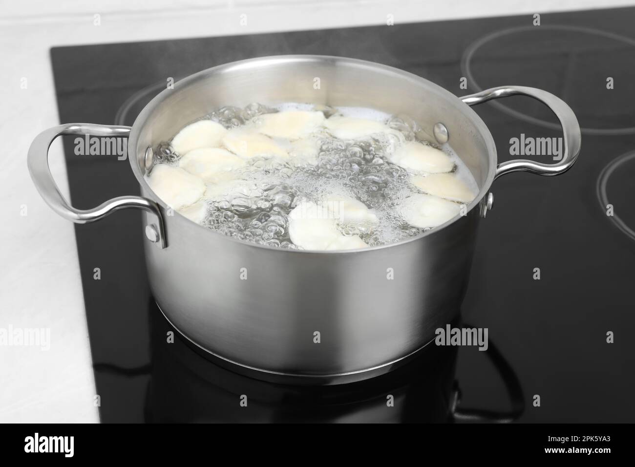 Cooking delicious dumplings in pot on cooktop Stock Photo - Alamy