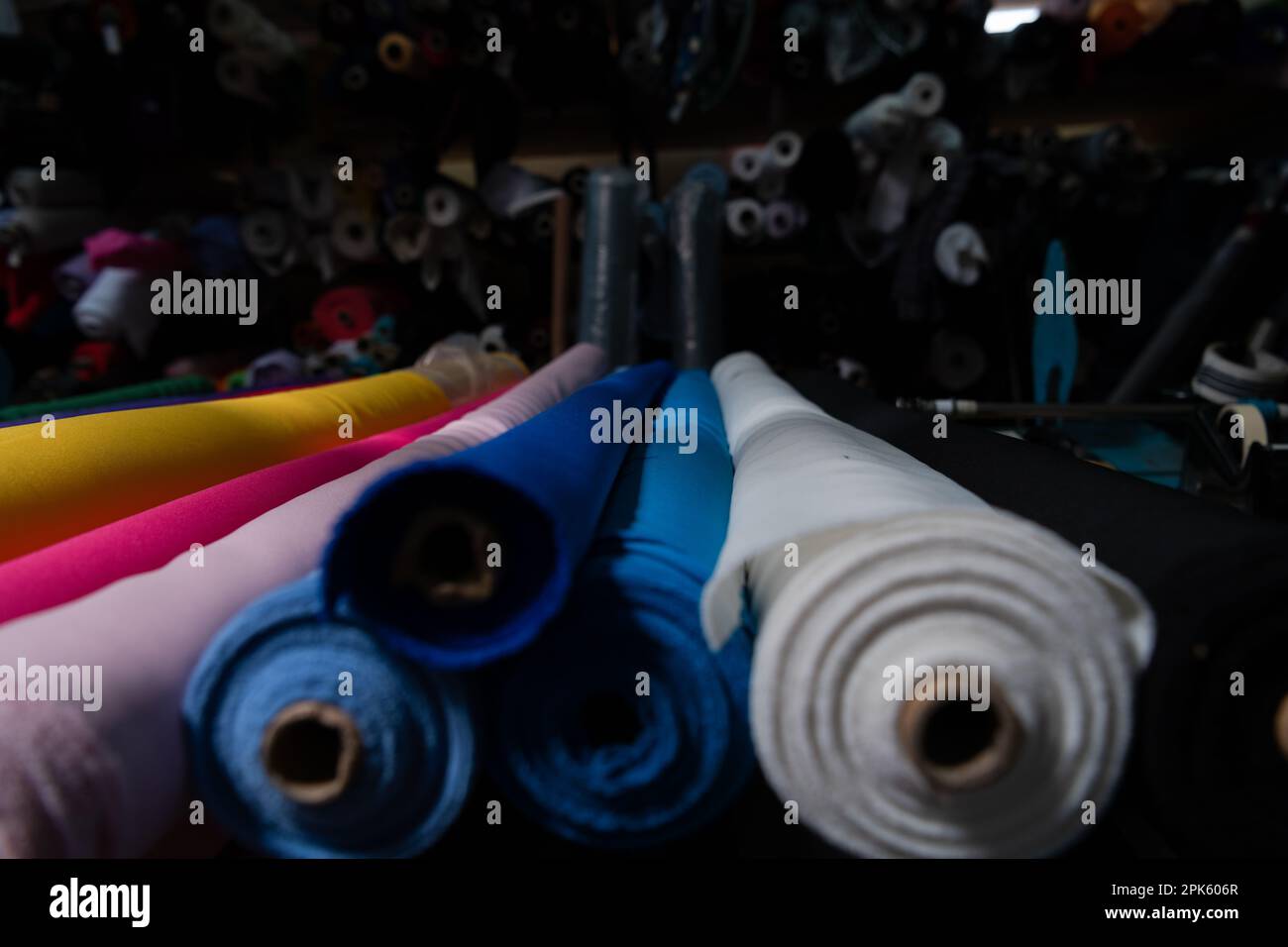 Interior of an industrial warehouse with fabric rolls samples. Small ...