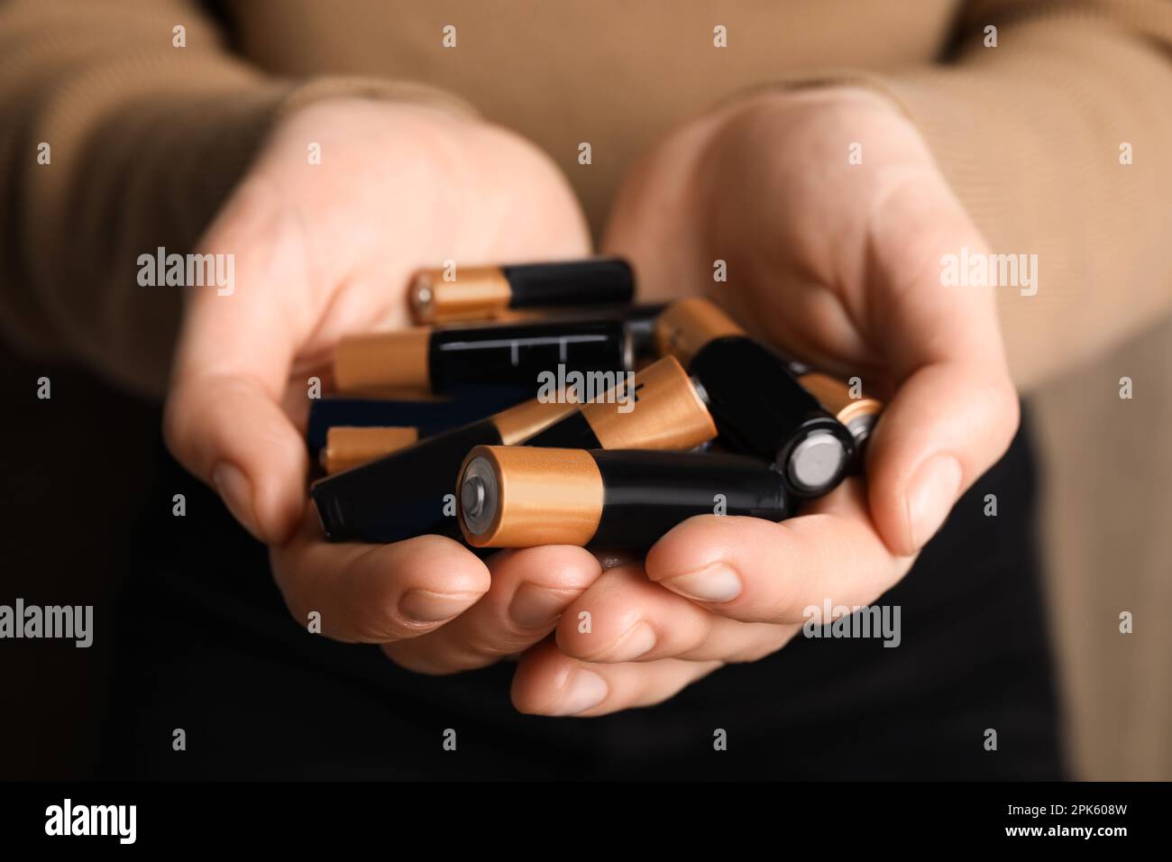 Woman holding many used electric batteries in her hands, closeup Stock ...